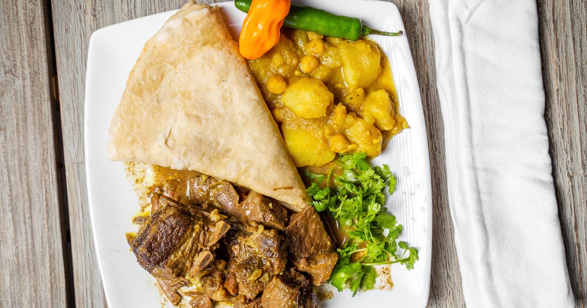 Curry Goat Roti - Roti - Our Signature Dish - Cafe Trinidad To Go ...